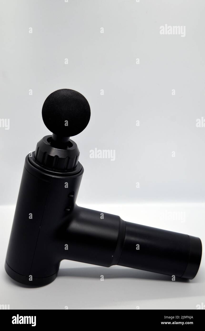 Isolated portrait black massage gun on white background Stock Photo - Alamy