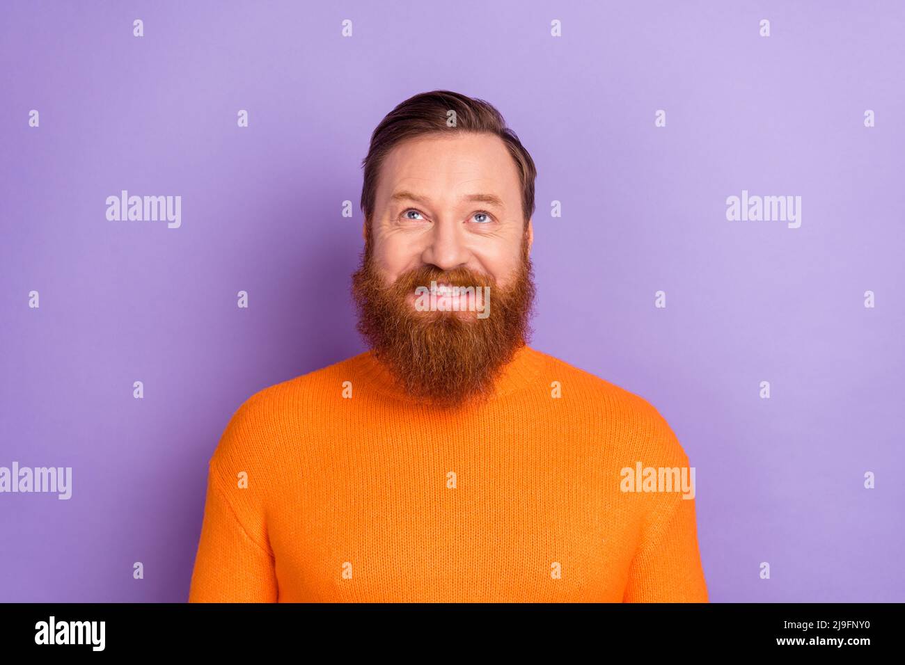 Photo of charming positive ginger man look up generate creative ideas ...