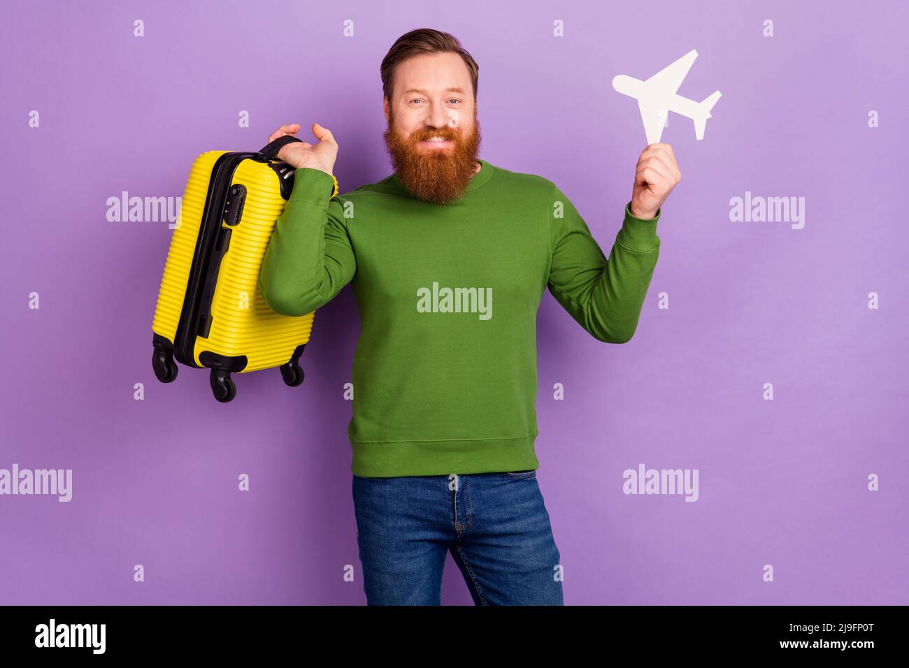 Portrait of attractive cheerful guy holding bag paper plane departure ...