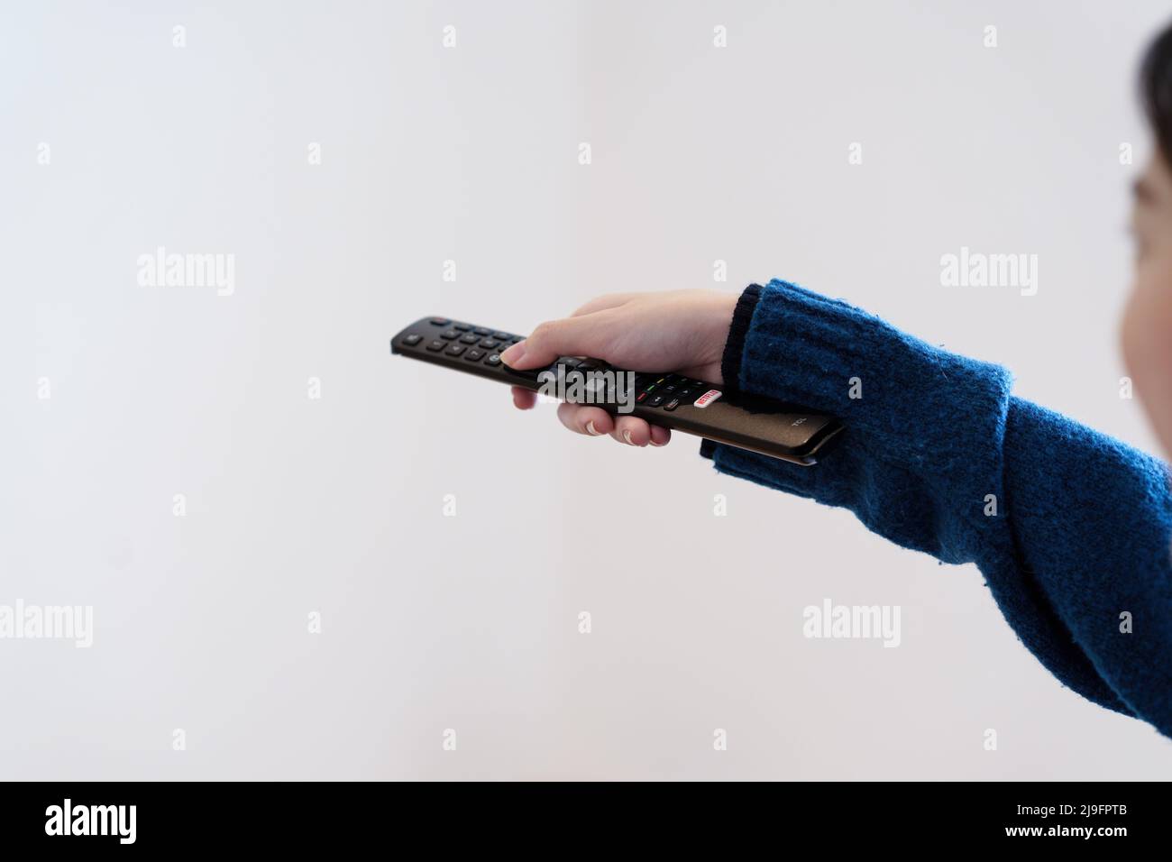 CHIANG MAI, THAILAND - MAY 23, 2022 : Woman with TV remote control in ...