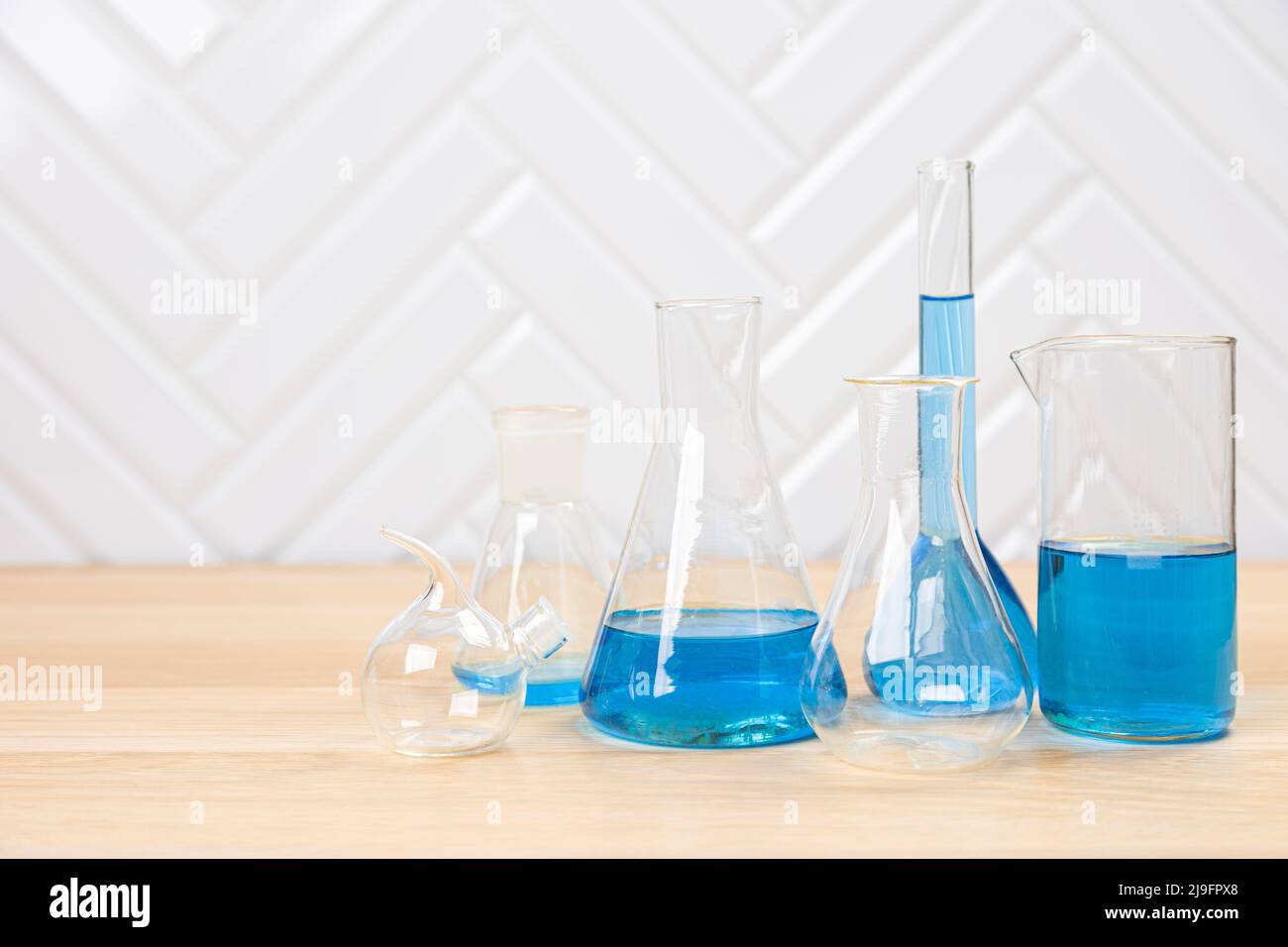 Laboratory glassware with test tubes. flasks, dropper, petri dishes ...
