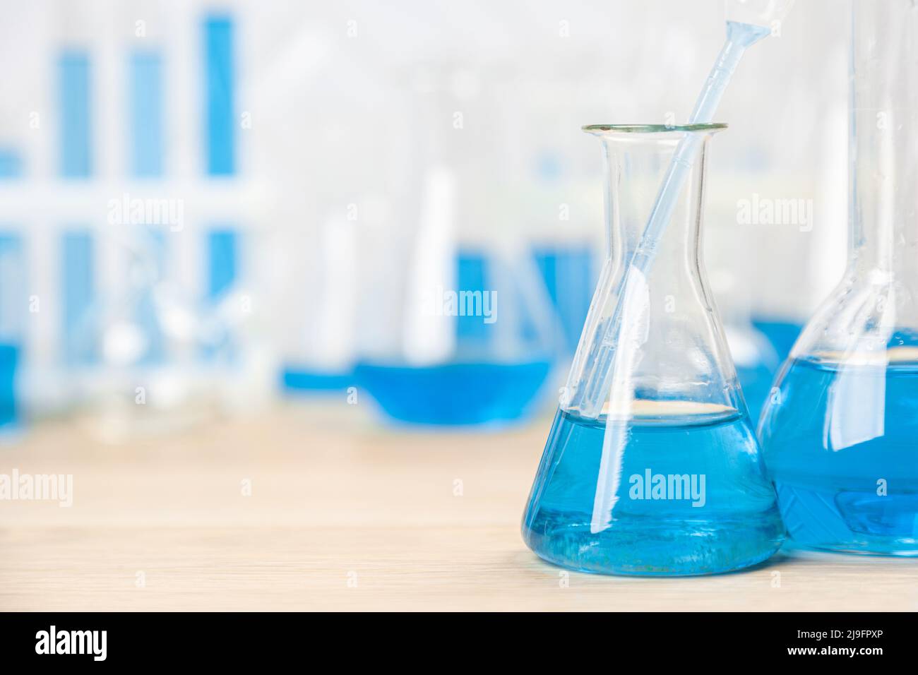 Laboratory glassware with blue liquid in a test tube. scientific ...