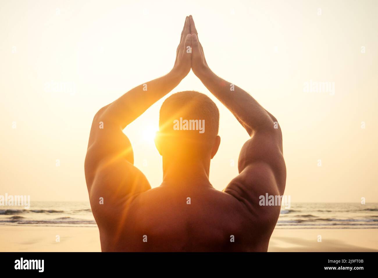 Man standing in yoga pose on ocean sunset paradise beach.Apollo ...