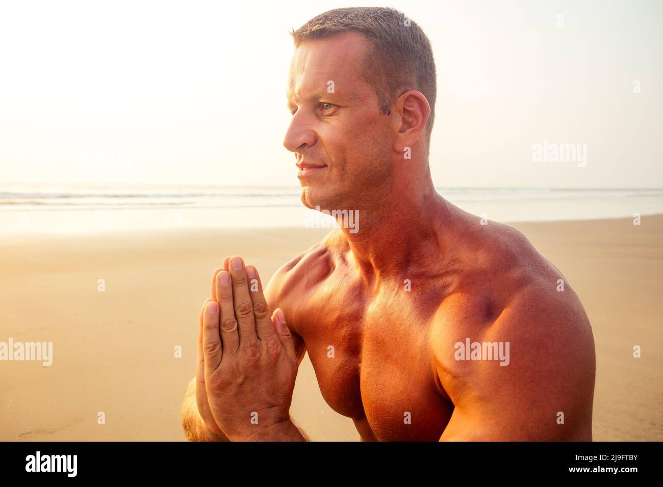 Man standing in yoga pose on ocean sunset paradise beach.Apollo ...