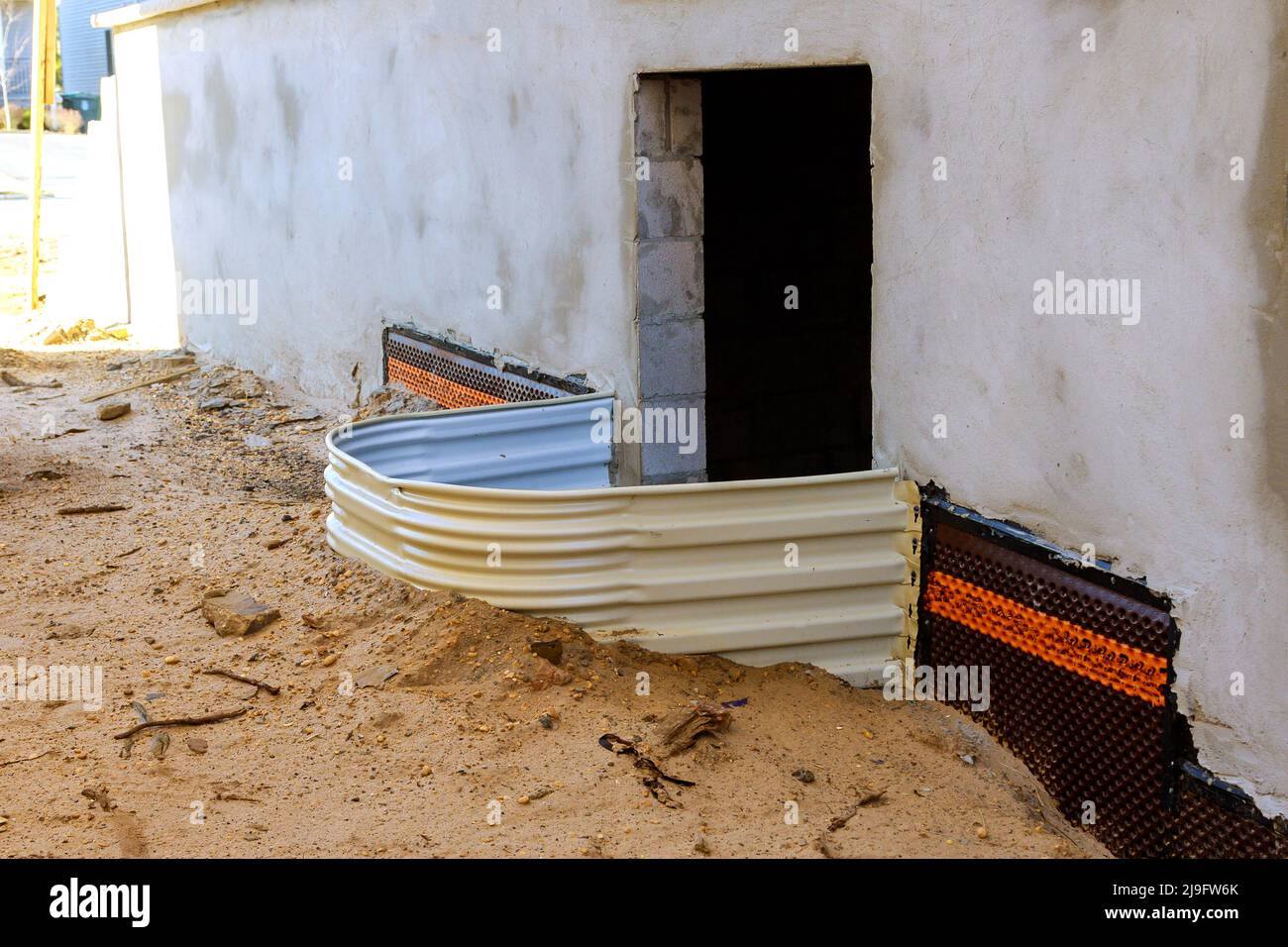 Unfinished basement with window well on basement construction Stock ...