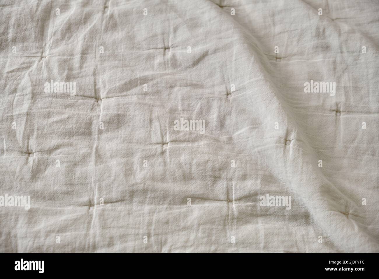 Beige crumpled bed linen fabric texture. Background of white cotton ...