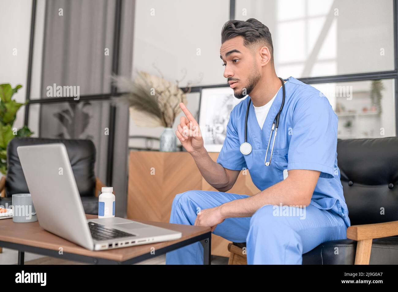 Qualified doctor conducting a virtual medical consultation Stock Photo ...