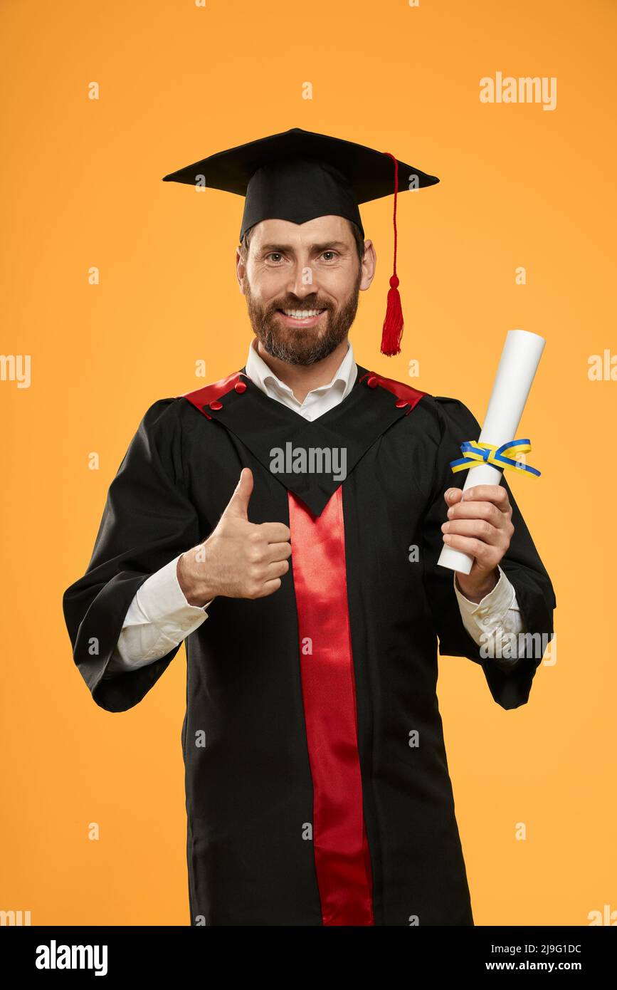 Front view of male with beard graduating from college, university ...