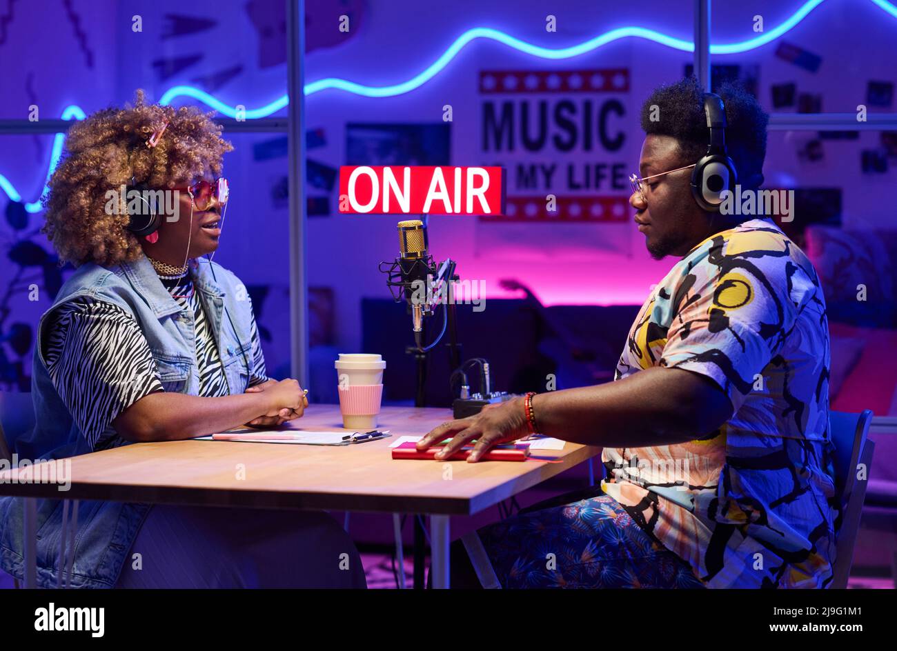 Young gen Z African American man and woman sitting in front of each ...