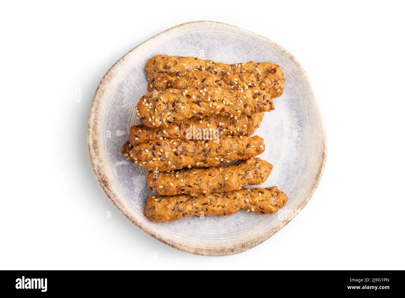 Crumble cookies with seasme and almonds on ceramic plate isolated on ...