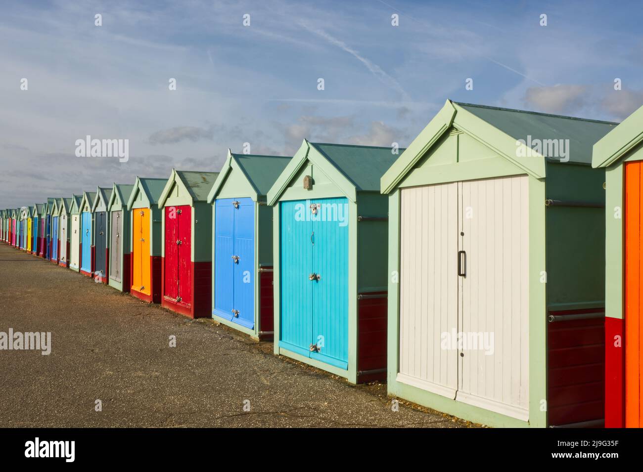 Colourful beach huts on the seafront promenade at Hove, Brighton in ...