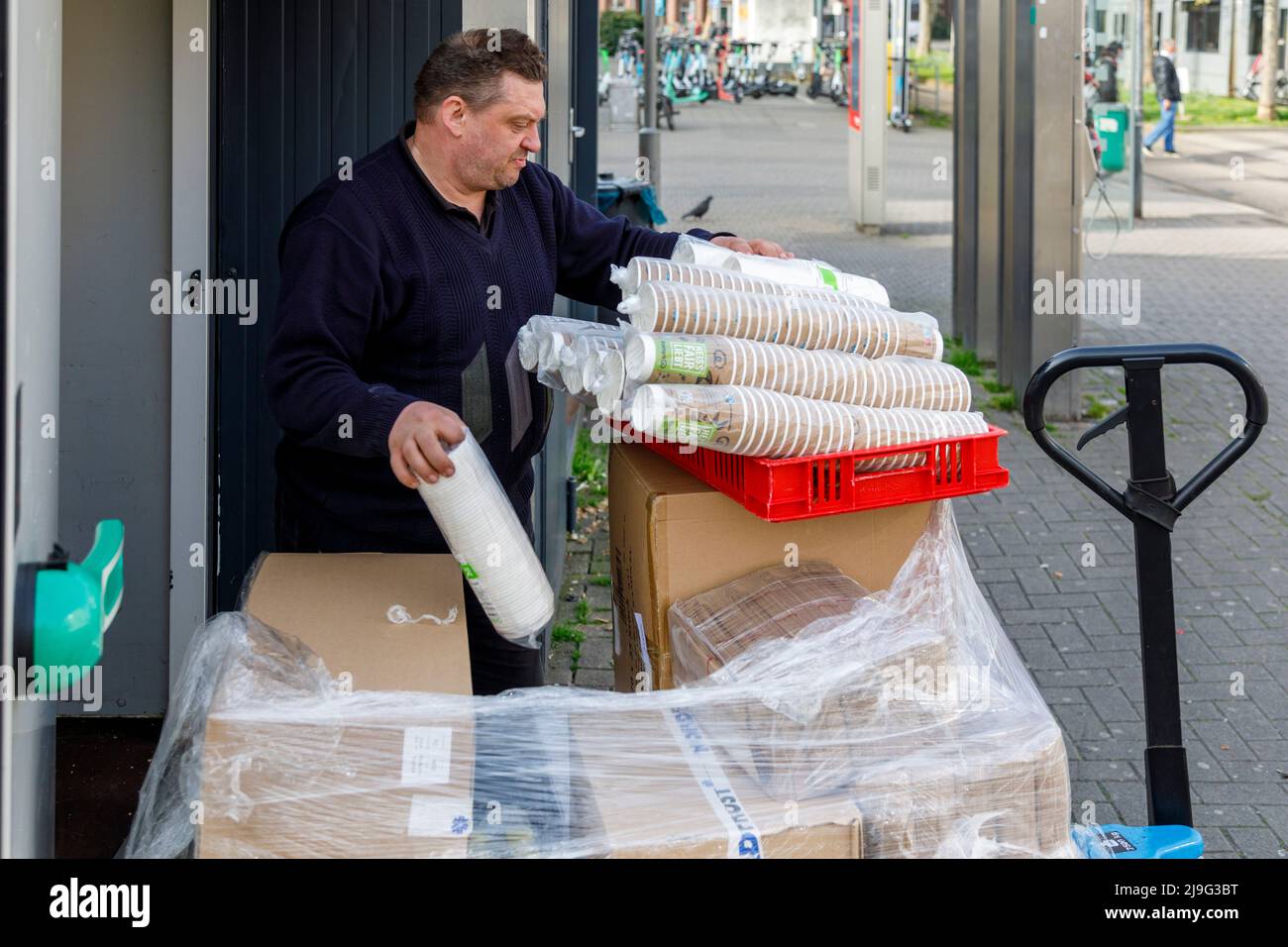 Delivery man cart groceries hi-res stock photography and images - Alamy
