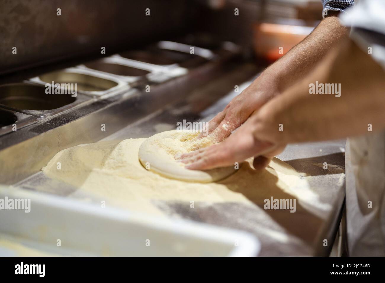 Pizza making process. Male chef hands making authentic pizza in the ...