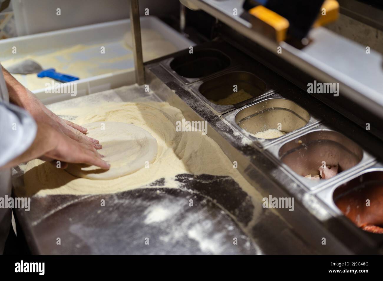 Pizza making process. Male chef hands making authentic pizza in the ...