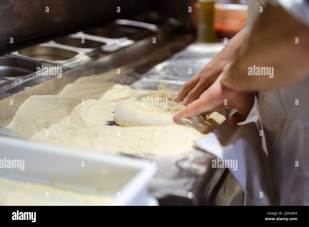Pizza making process. Male chef hands making authentic pizza in the ...