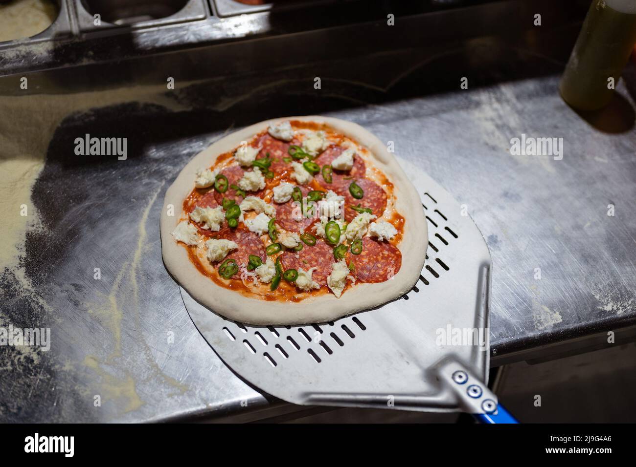 Pizza making process. Male chef hands making authentic pizza in the ...