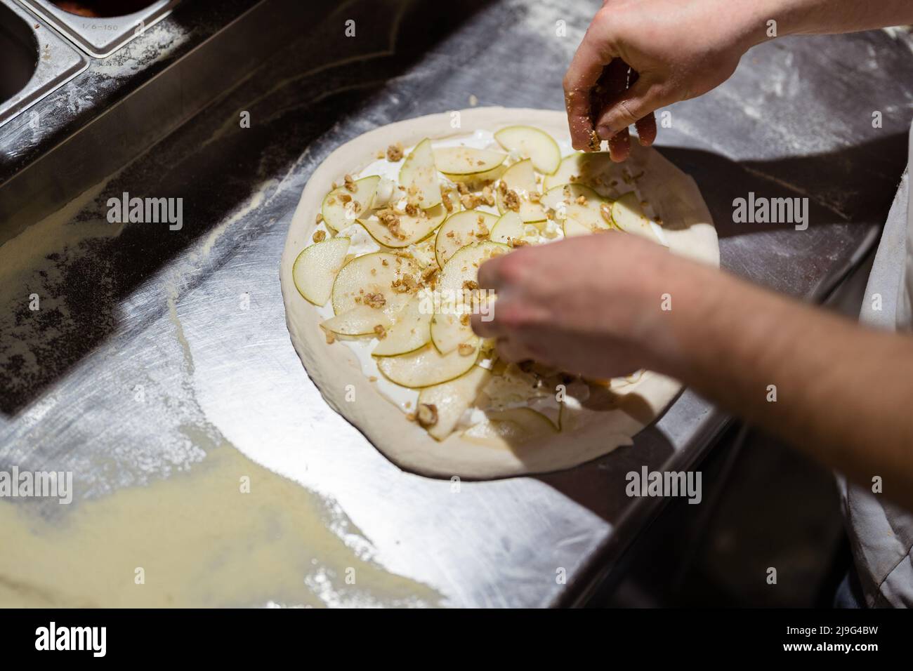 Pizza making process. Male chef hands making authentic pizza in the ...