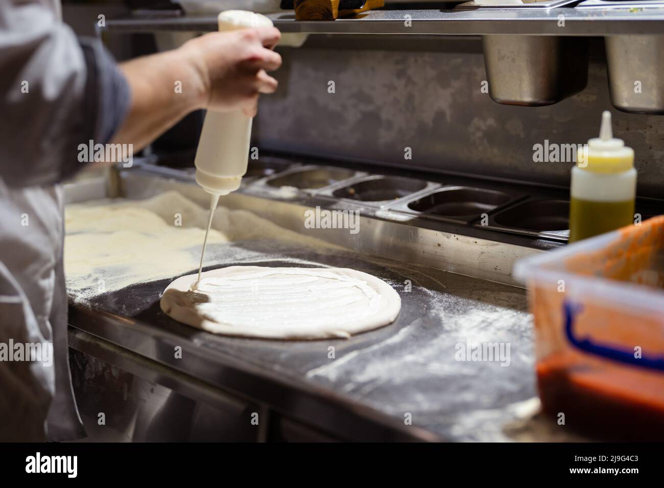 Pizza making process. Male chef hands making authentic pizza in the ...