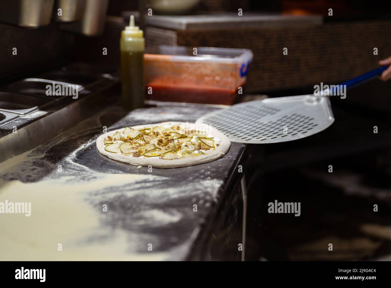 Pizza making process. Male chef hands making authentic pizza in the ...