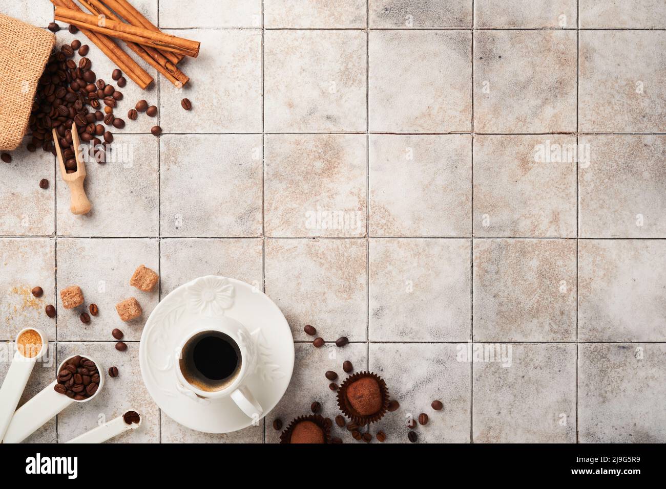 Coffee background. Measuring spoons with ground coffee, beans, cup and ...