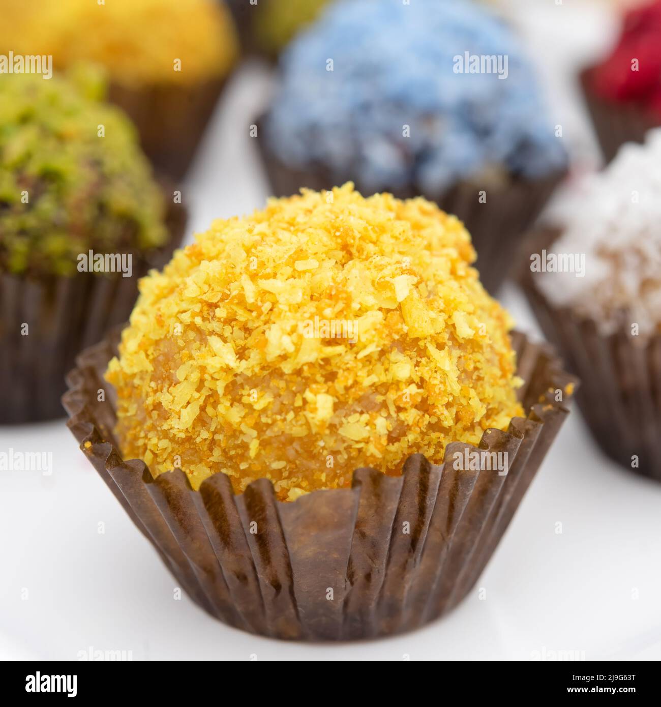 closeup of colourful sweet balls with different tastes on white ...