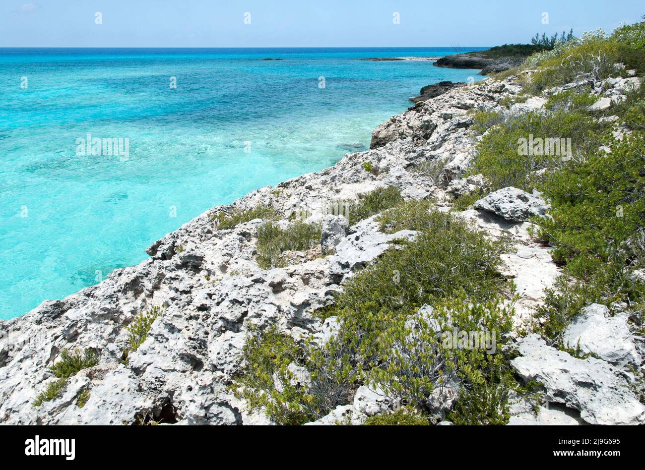 The view of turquoise color waters and a rocky shore on Half Moon Cay ...