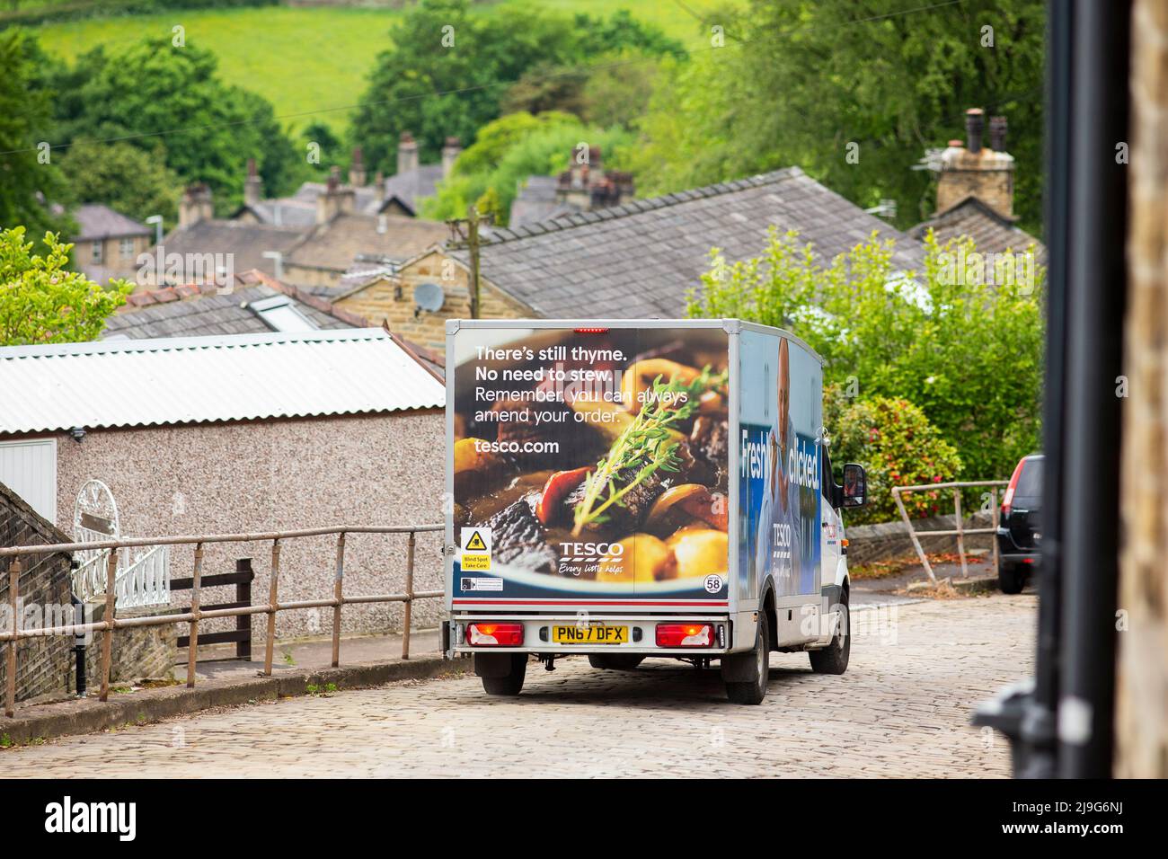 A Tesco supermarket home delivery van on a cobbled hill near Halifax ...