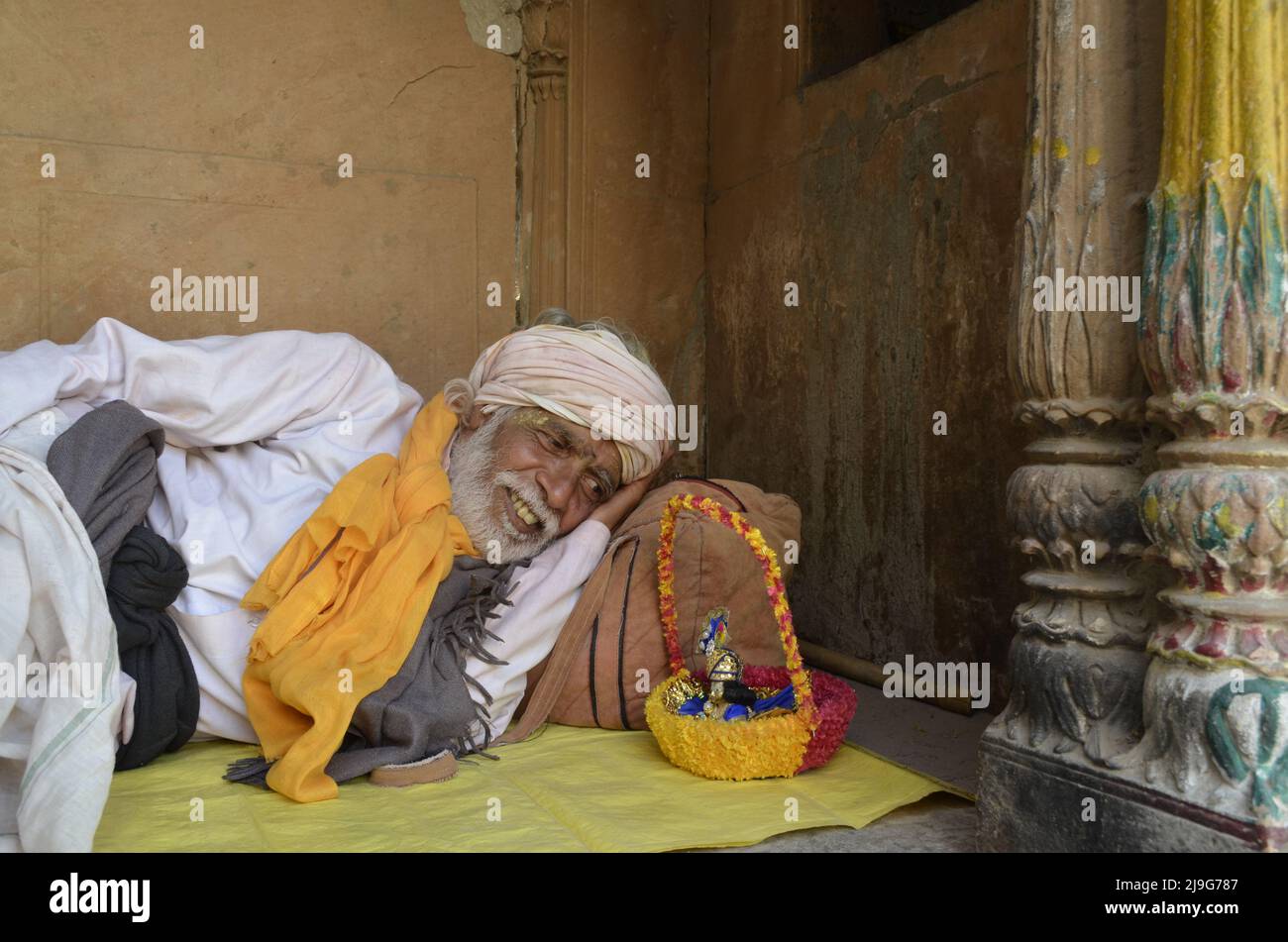 A Devotee is taking rest during mid-day in Vrindavan with his idol Lord ...