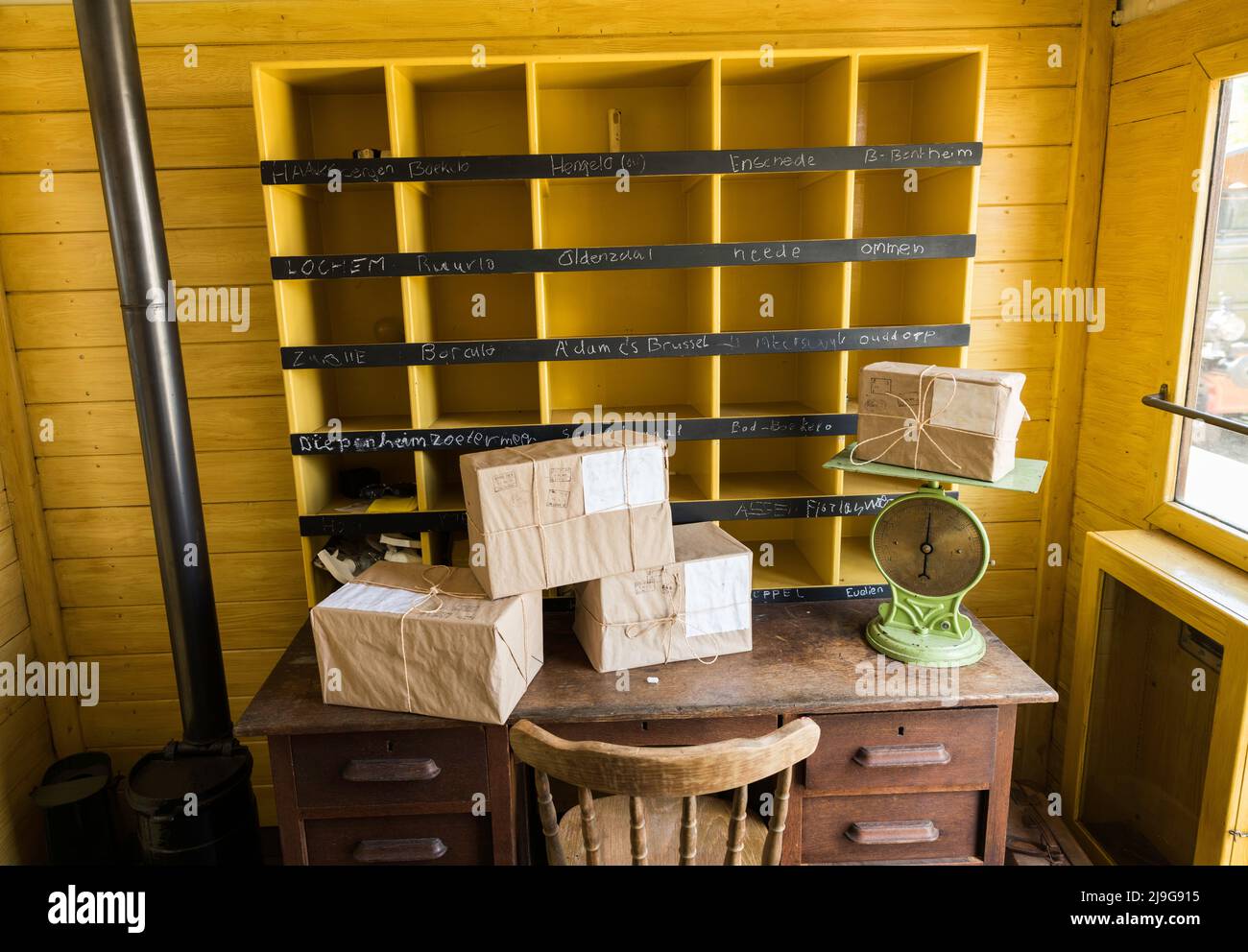the inside of an old mail train with desk and sortinh boxes Stock Photo ...