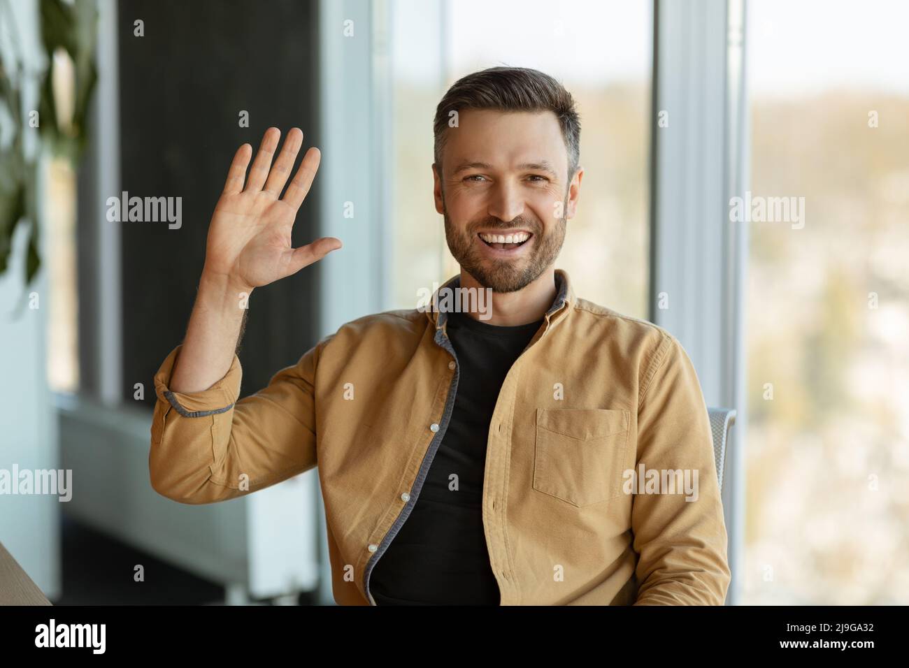 Businessman smiling camera waving hi-res stock photography and images ...