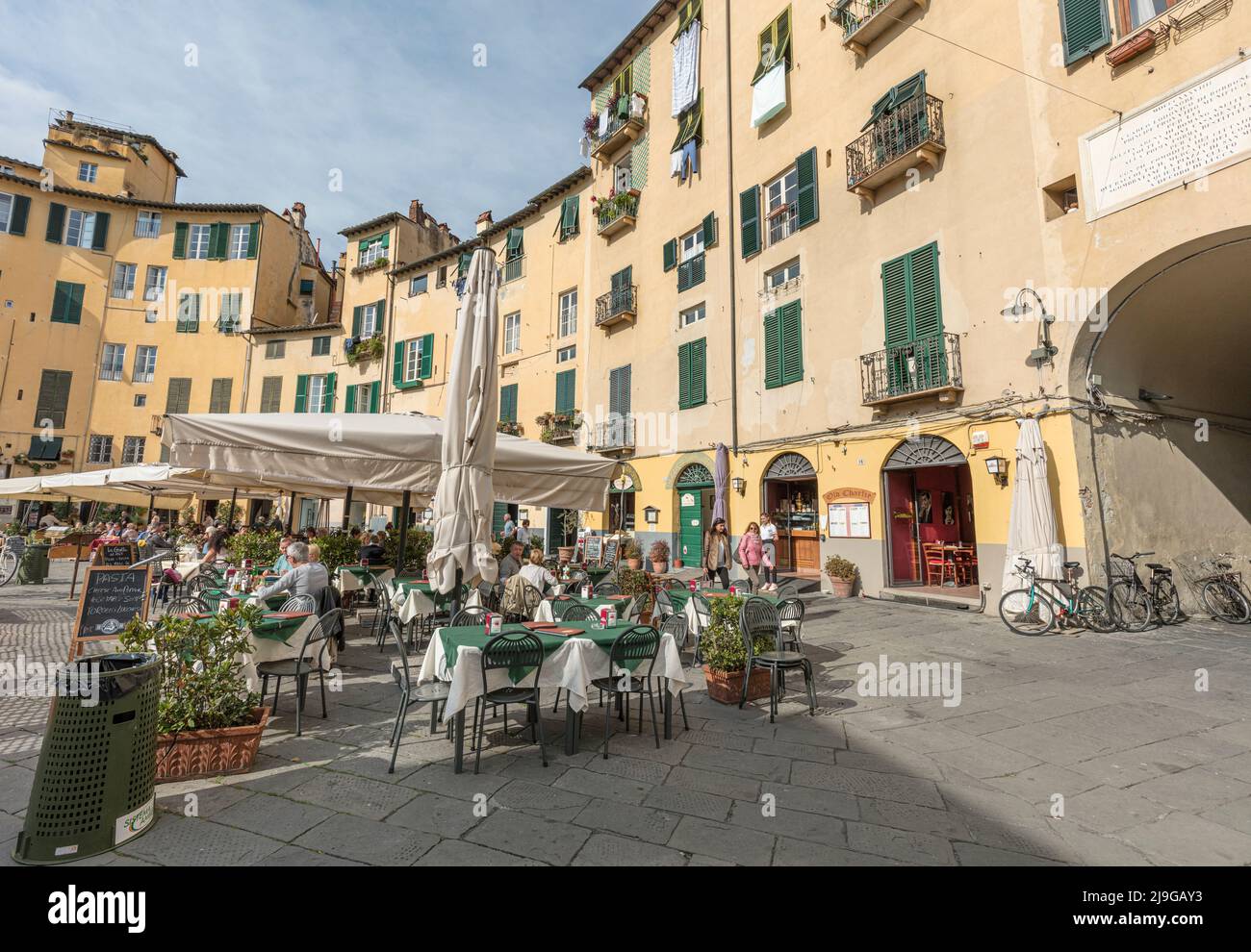 People in restaurants and cafes in Piazza dell'Anfiteatro in Old Town ...