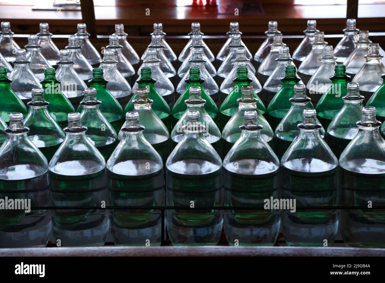 Rows of open glass bottles filled with fresh water Stock Photo - Alamy