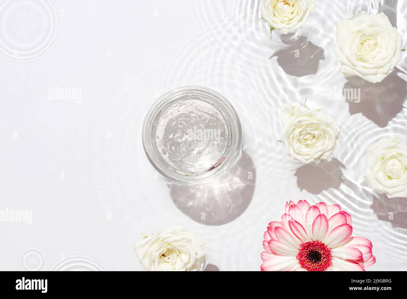 Jar of hydrating gel and flowers Stock Photo - Alamy
