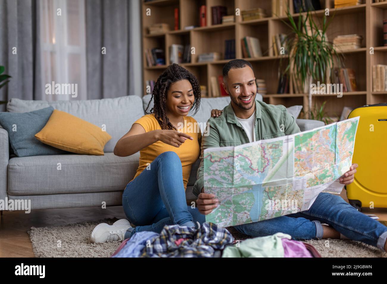 Happy family with travel map hi-res stock photography and images - Alamy