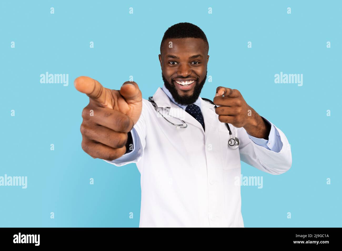 Cheerful African American Male Doctor In Uniform Pointing Fingers At ...