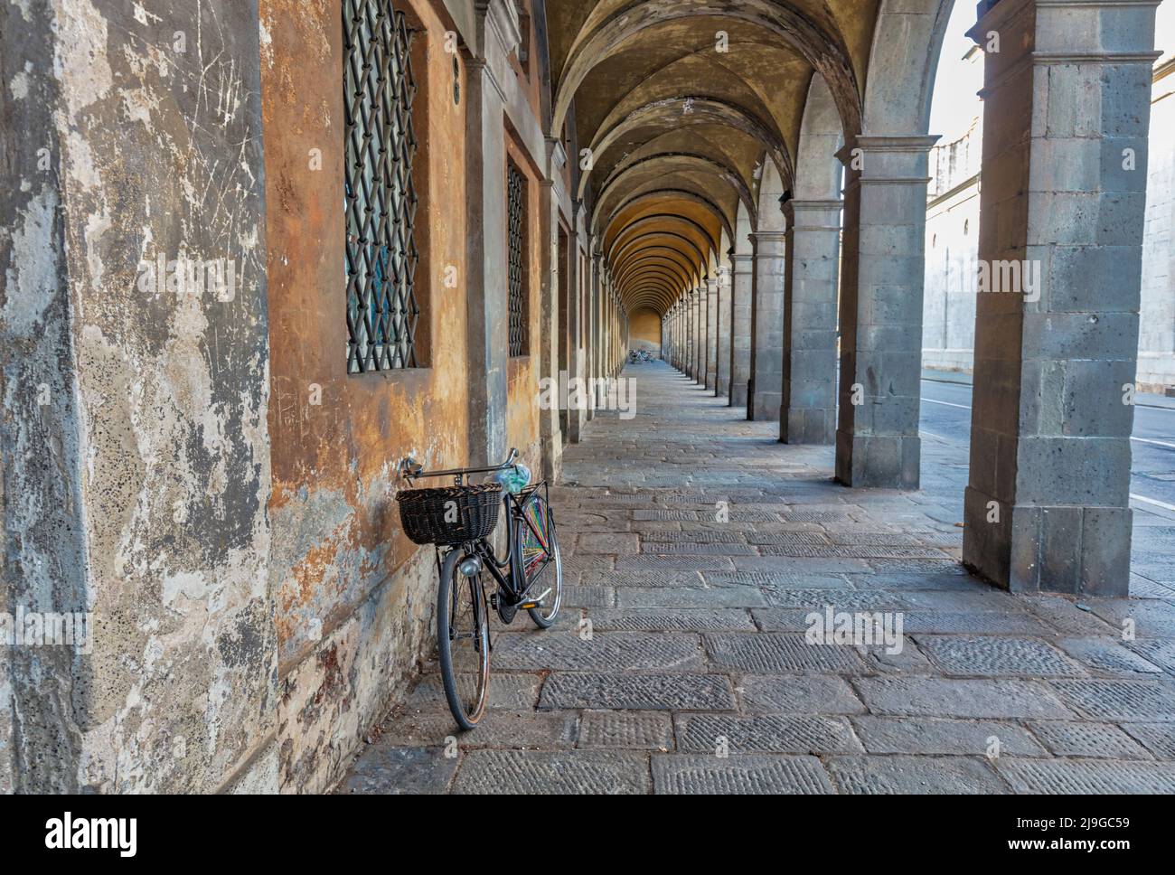 Bicycle stands by numerous arches in arcade of the Biblioteca Universit ...