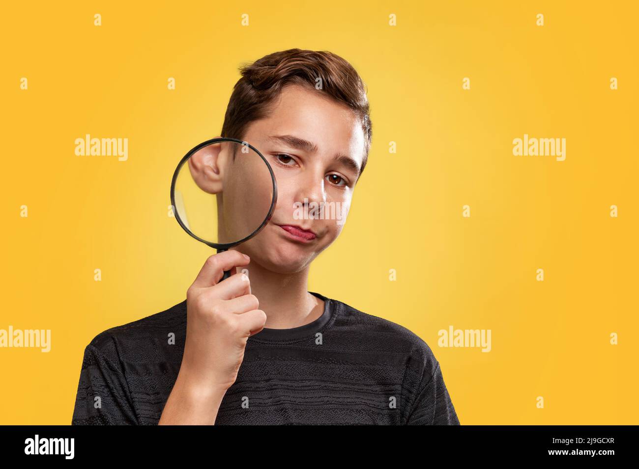 The concept of teenage acne. A teenage boy with a distressed face ...