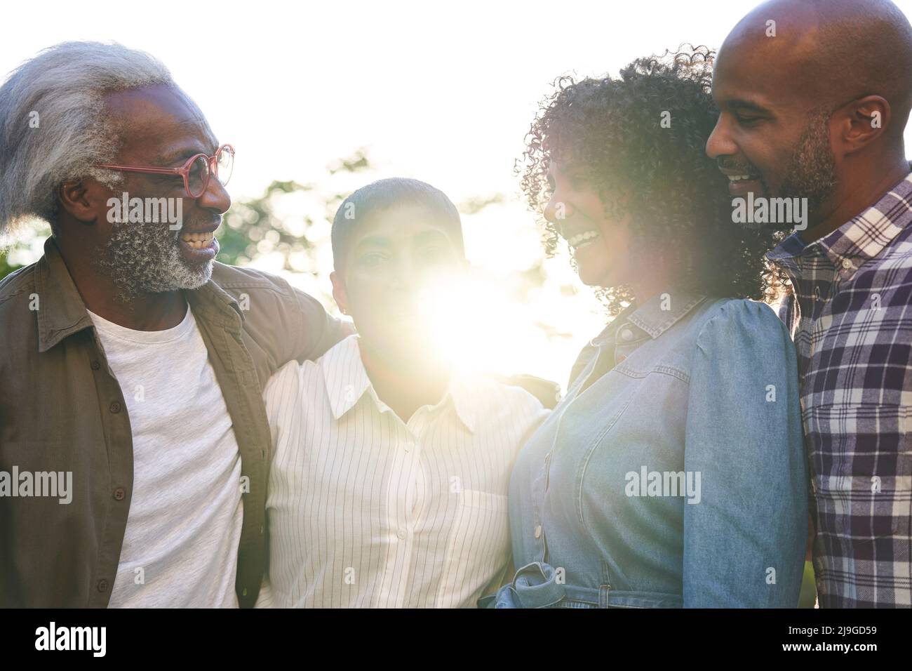 Happy multi-generation family standing in balcony Stock Photo - Alamy
