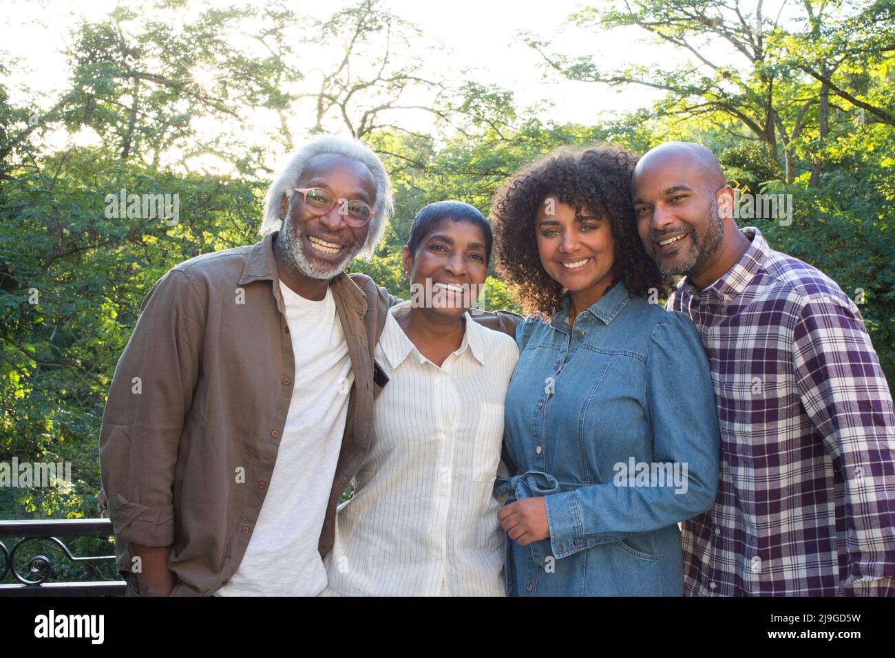 Happy multi-generation family standing in balcony Stock Photo - Alamy