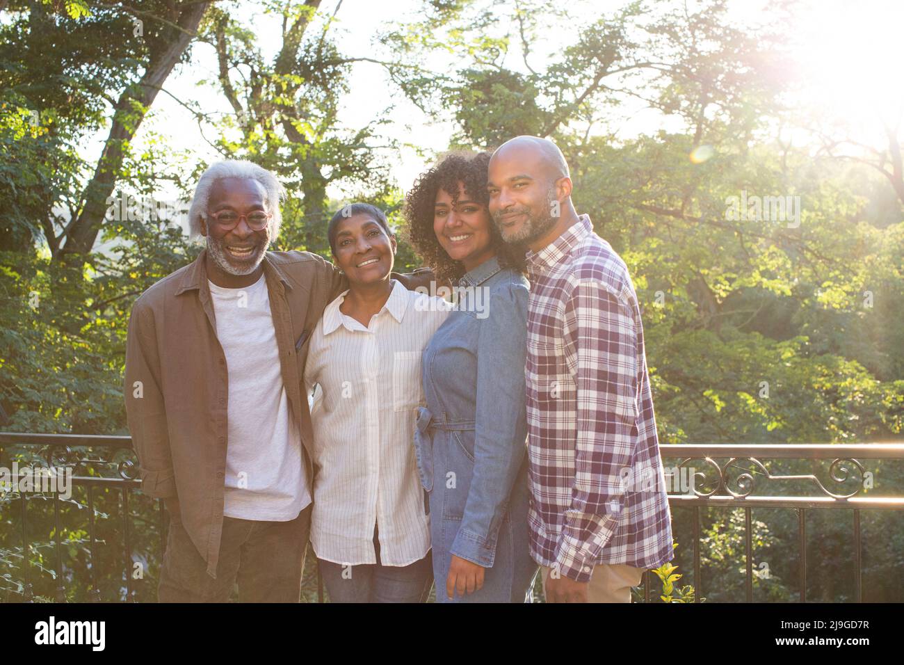 Happy multi-generation family standing in balcony Stock Photo - Alamy