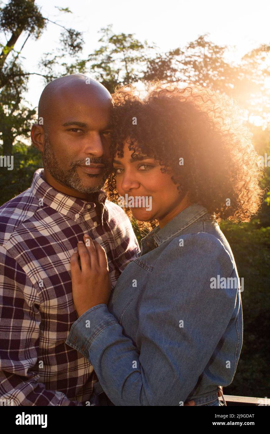 Happy couple embracing each other in balcony Stock Photo - Alamy