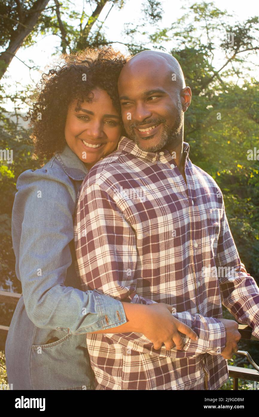 Happy couple embracing each other in balcony Stock Photo - Alamy