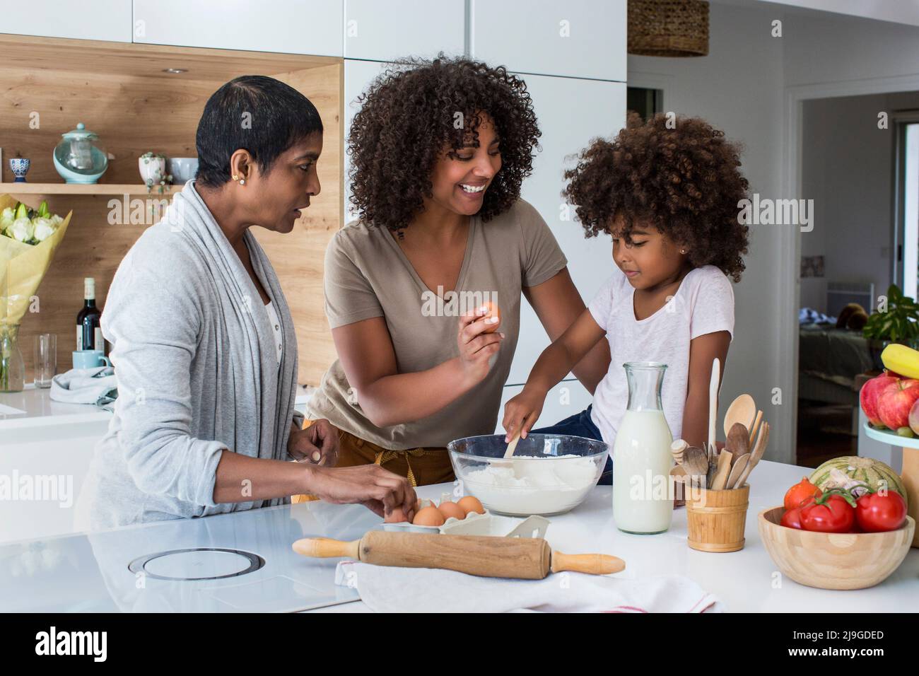 Multi-generation family preparing cookies Stock Photo - Alamy