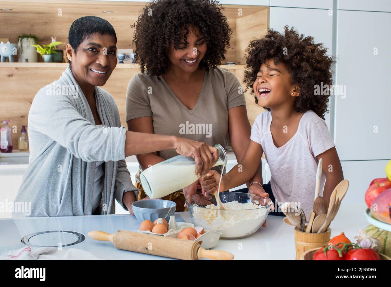 Multi-generation family preparing cookies Stock Photo - Alamy