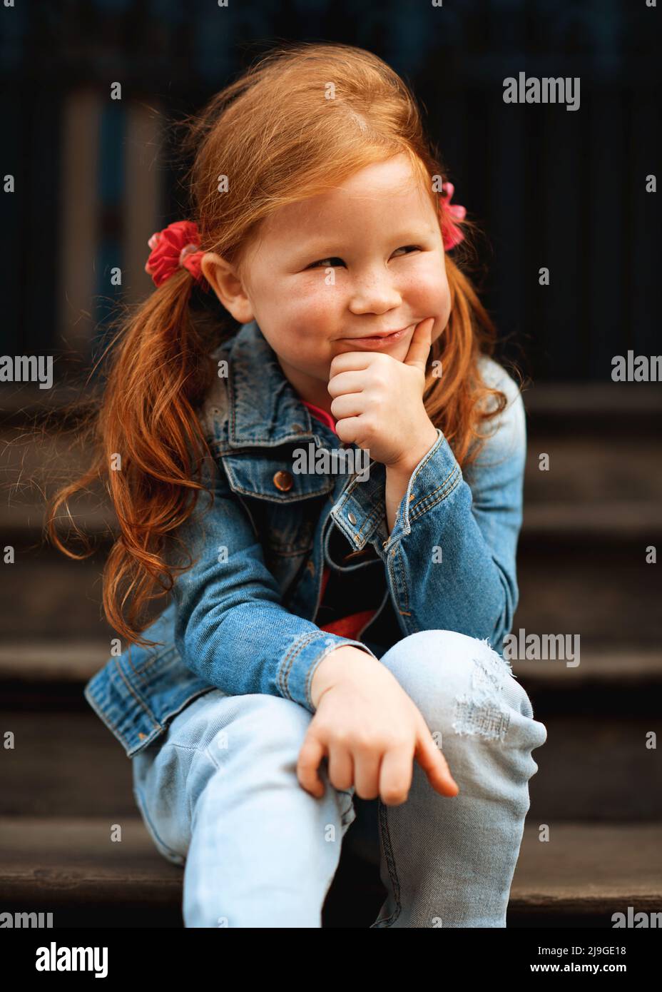 little girl with red hair sitting on the road and thinking Stock Photo ...
