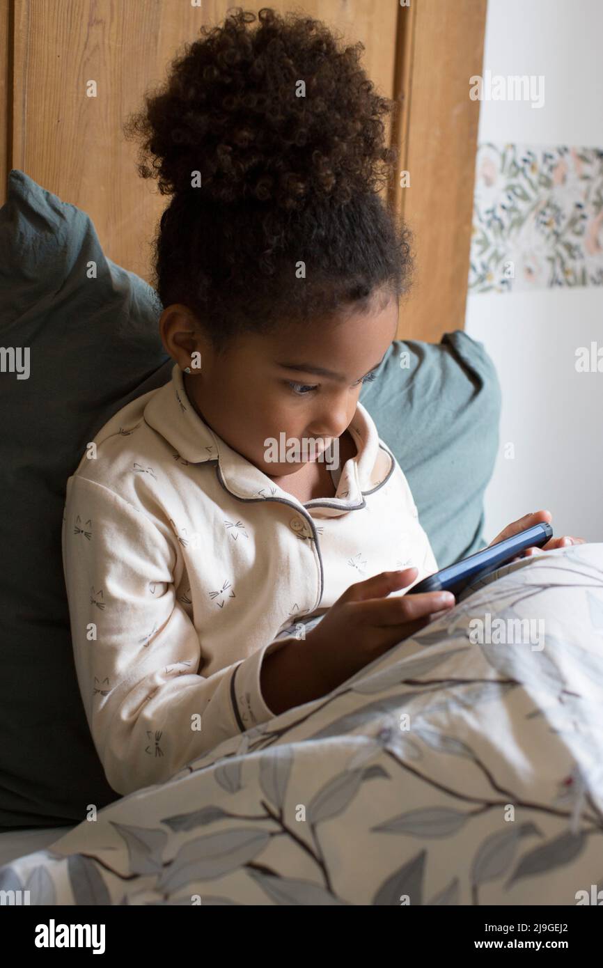 Girl looking at smart phone Stock Photo - Alamy