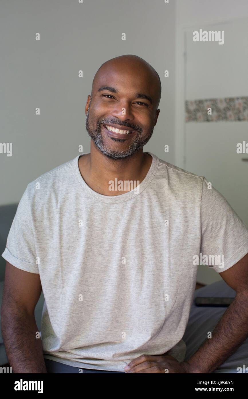Smiling man sitting on bed Stock Photo - Alamy Smiling man sitting on bed Stock Photo - Alamy