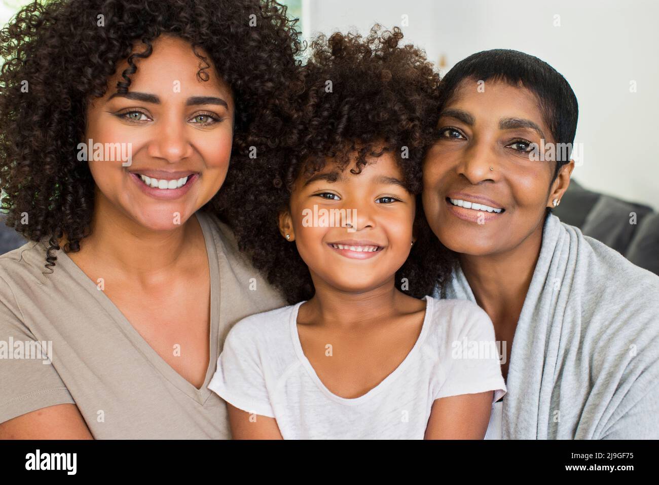 Happy multi-generation family sitting in living room Stock Photo - Alamy