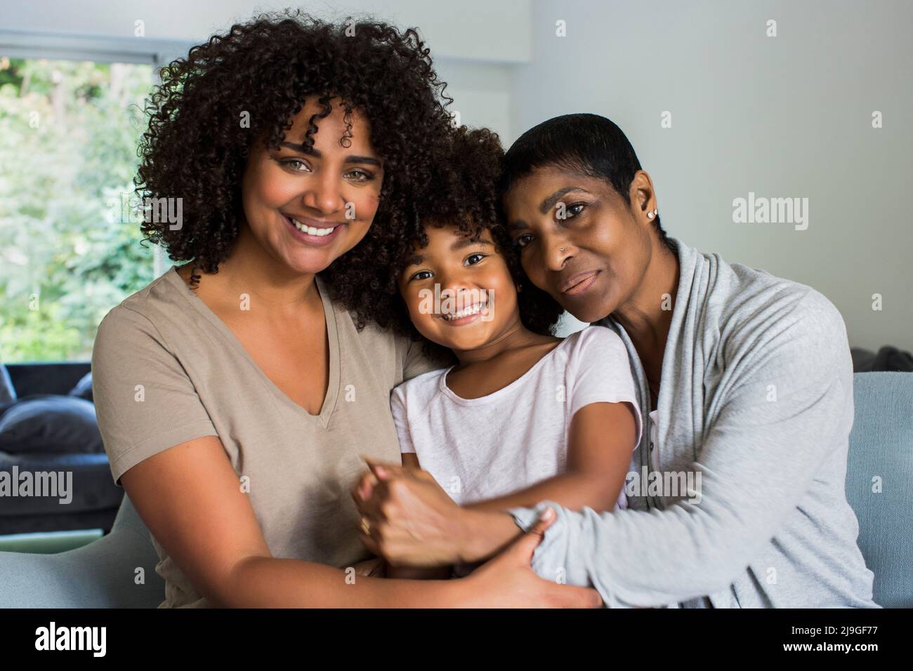 Happy multi-generation family sitting in living room Stock Photo - Alamy
