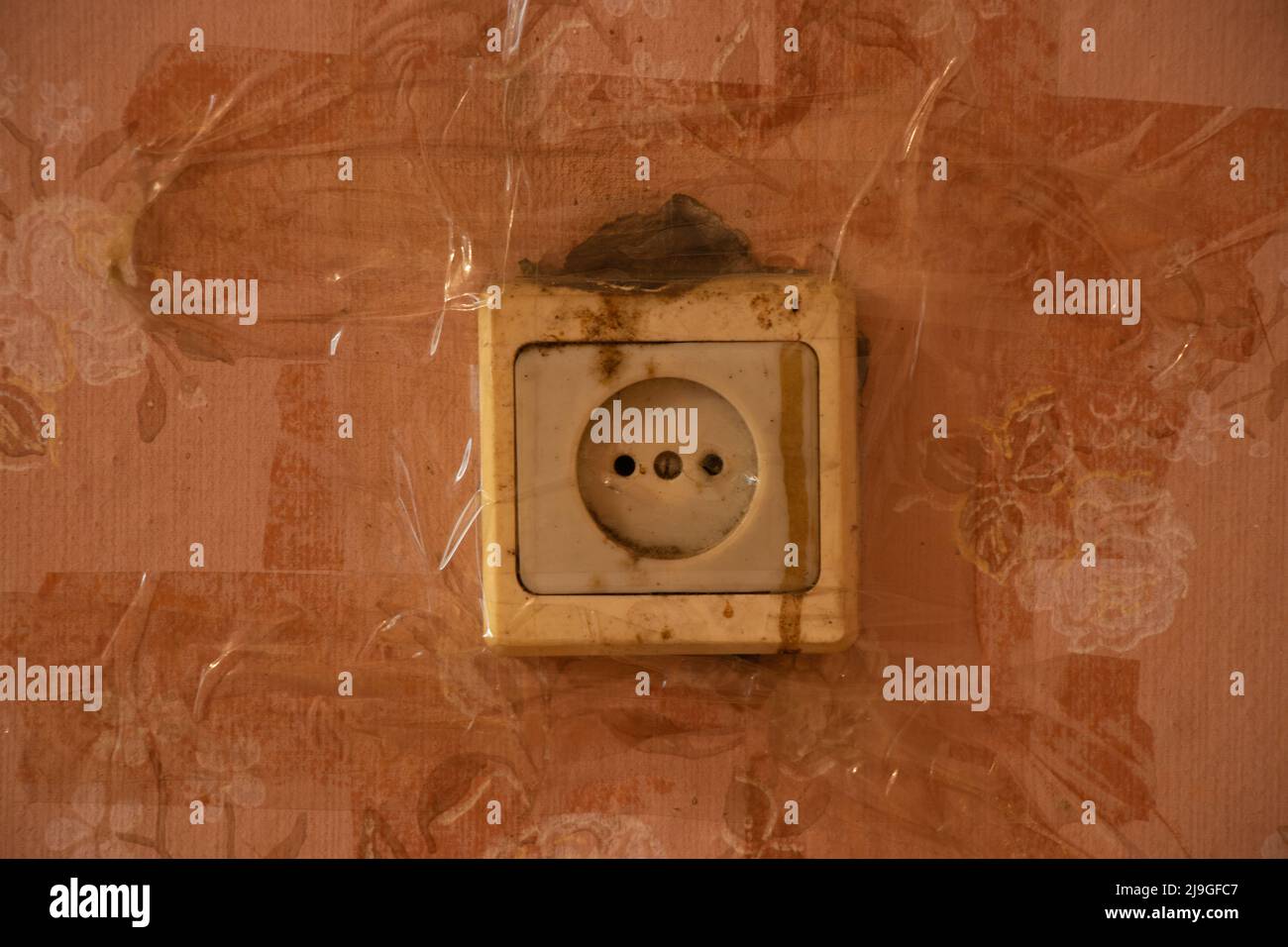 old dirty socket in apartment, dangerous socket on the wall close up ...